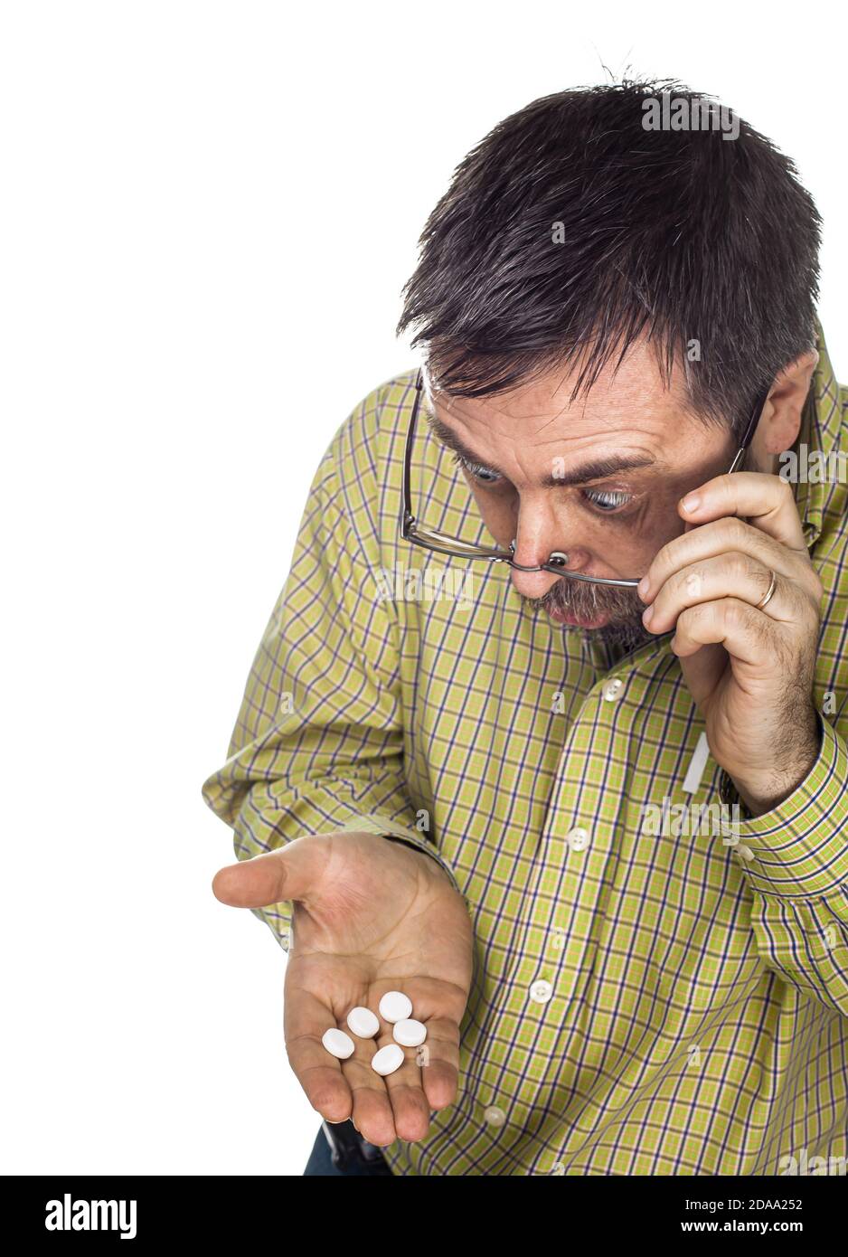Medicine and health concept. Elderly man with pills in hands on a white ...