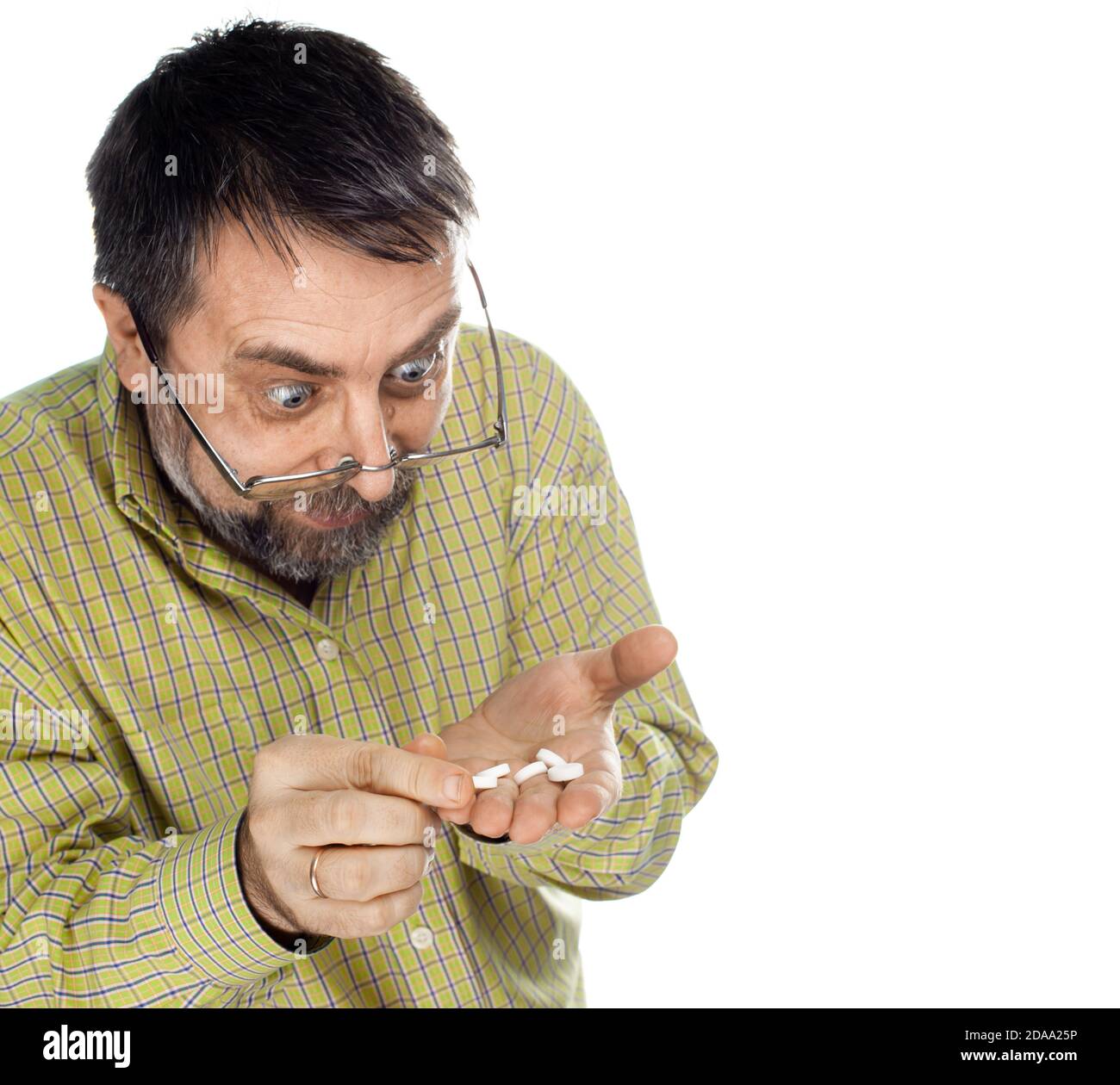 Medicine and health concept. Elderly man with pills in hands on a white ...