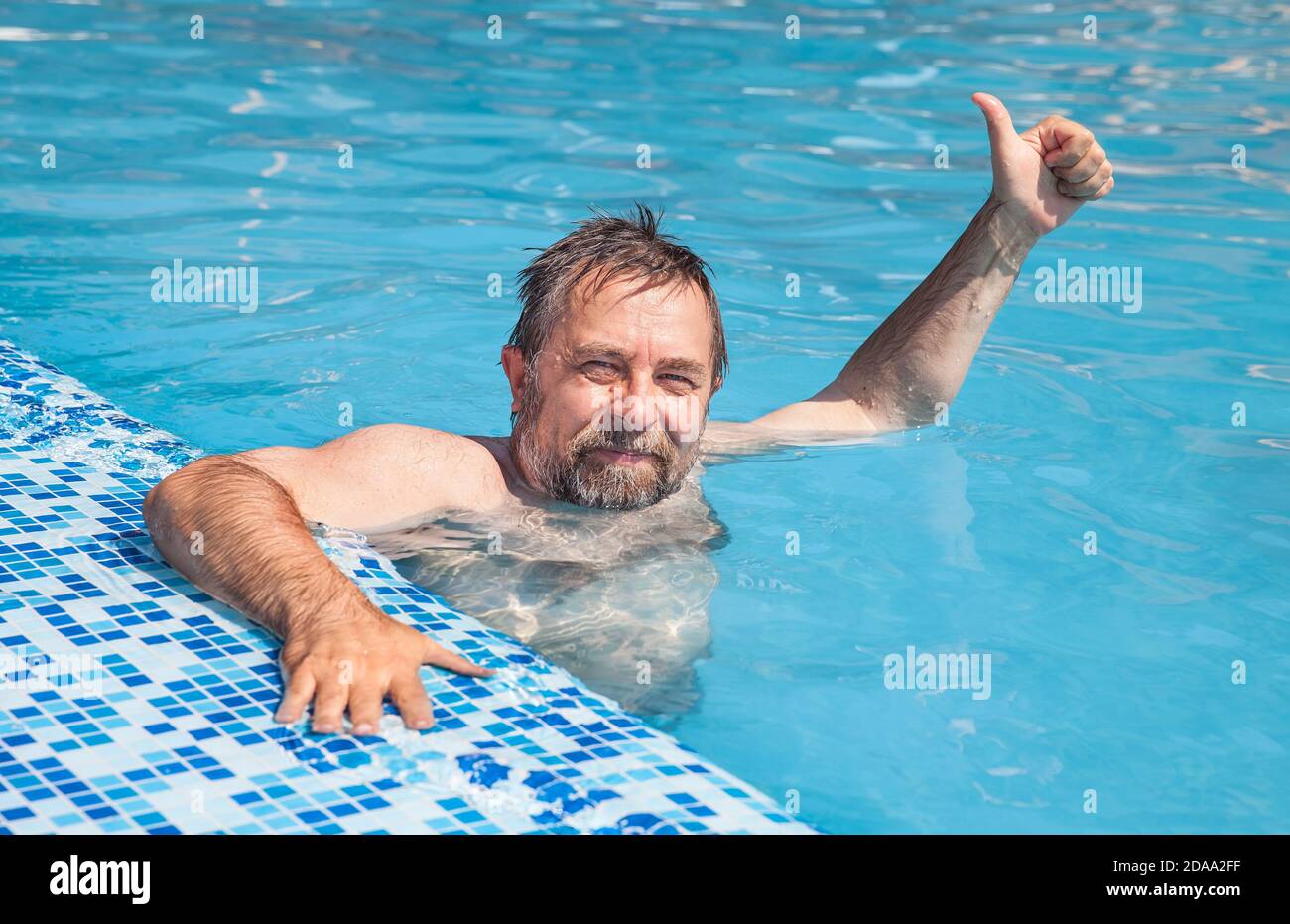 Healthy lifestyle. Happy middle-aged man in a swimming pool Stock Photo ...