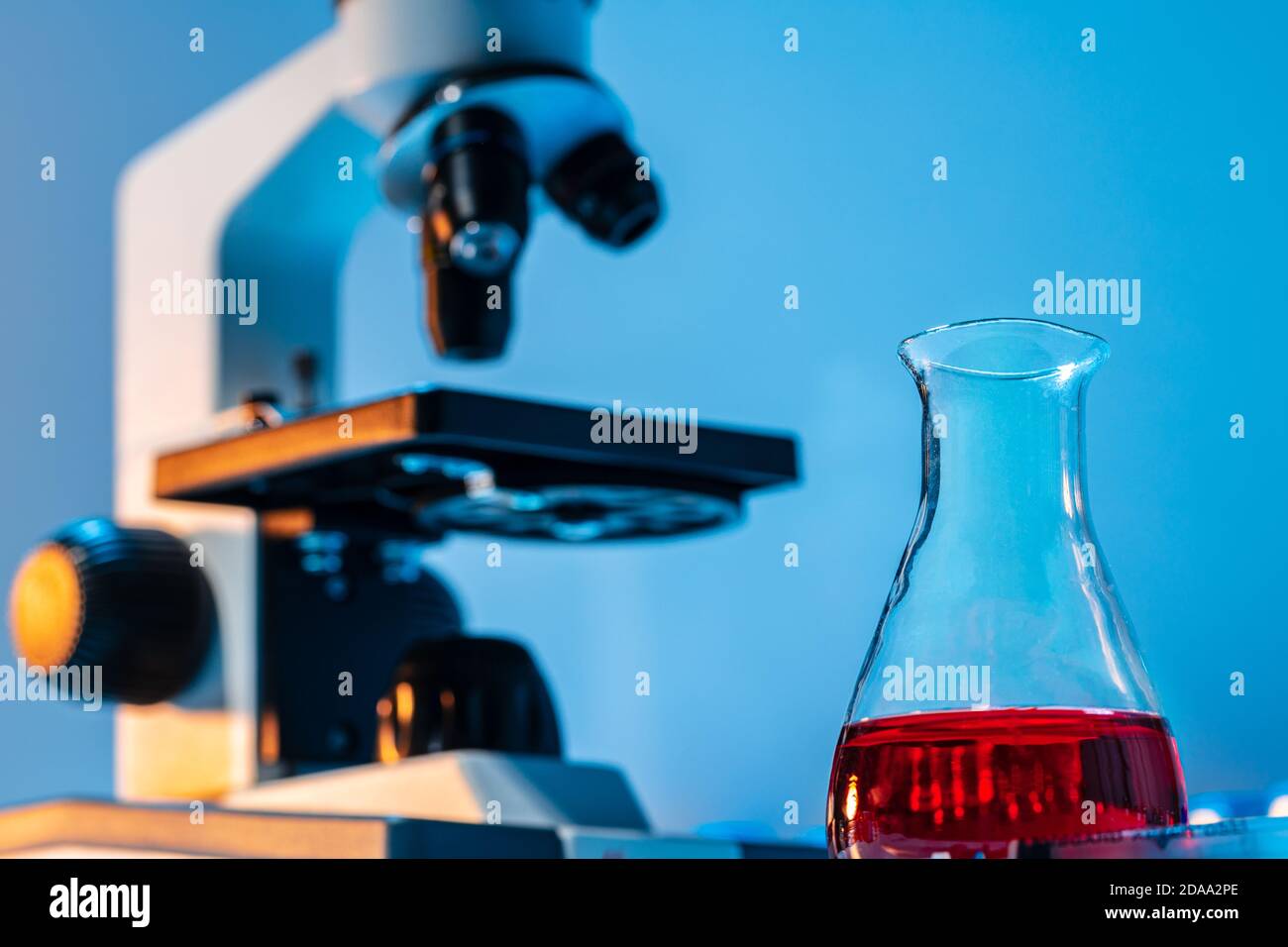 Medical vial with medication near microscope photo Stock Photo - Alamy