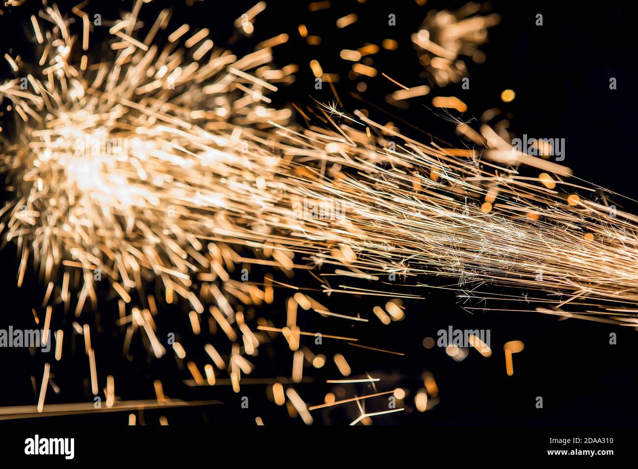 bright sparks of metal against dark background Stock Photo - Alamy