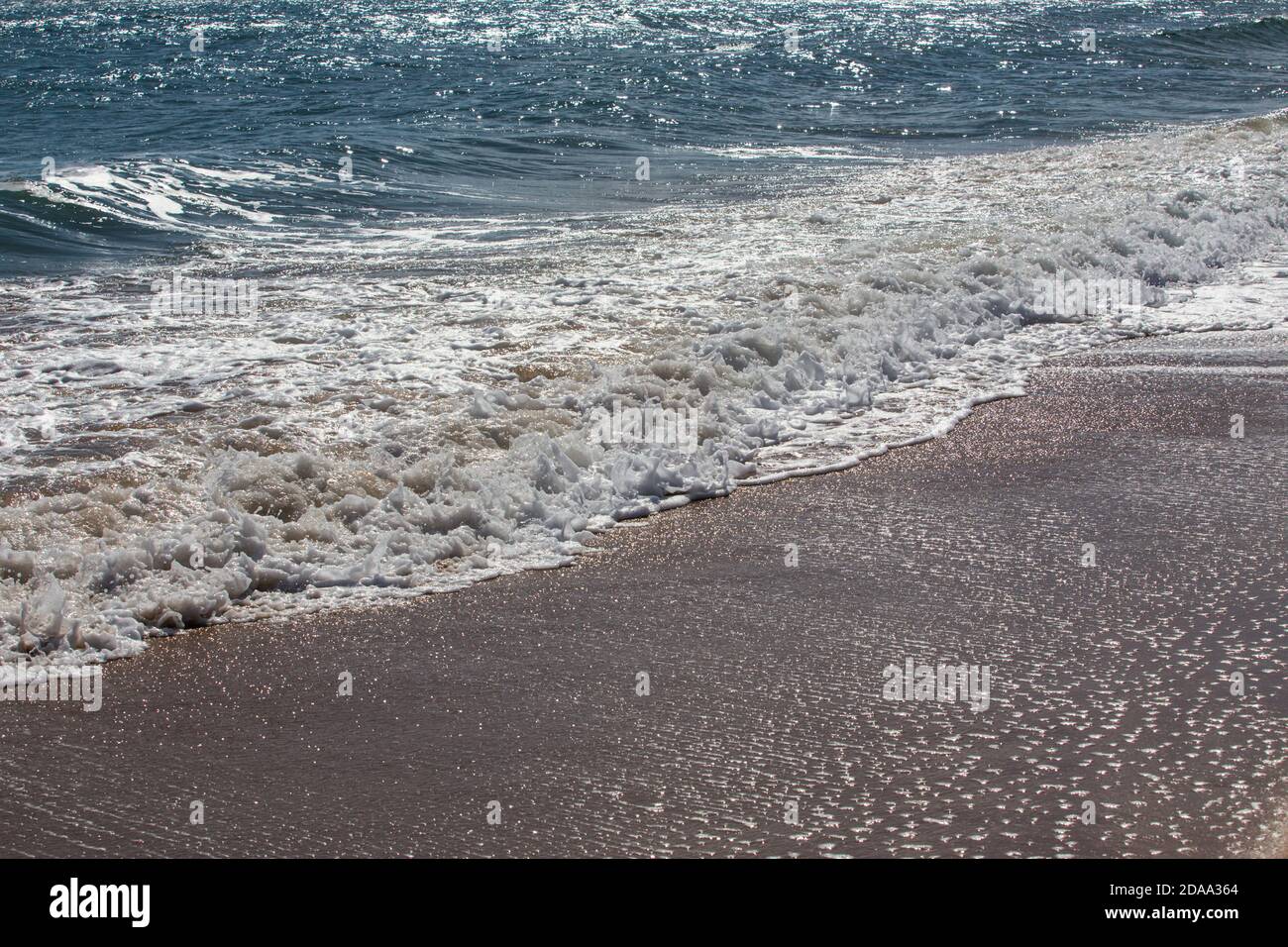 Waves roll on sandy shore hi-res stock photography and images - Alamy