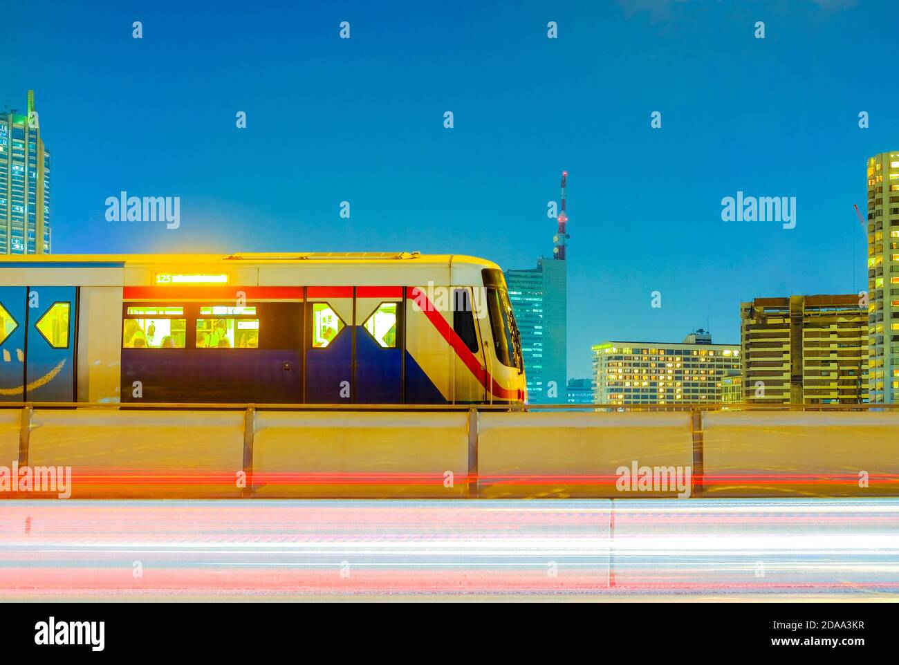 BTS Sky Train on cityscape background and light trails of traffic ...