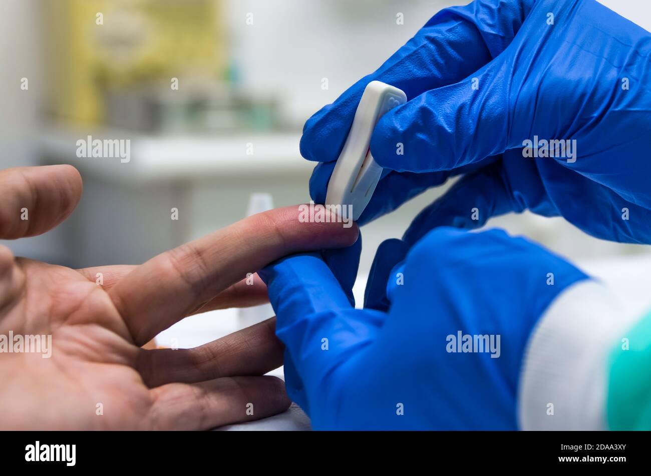 Hands of a nurse with individual protection equipment and patient, in ...