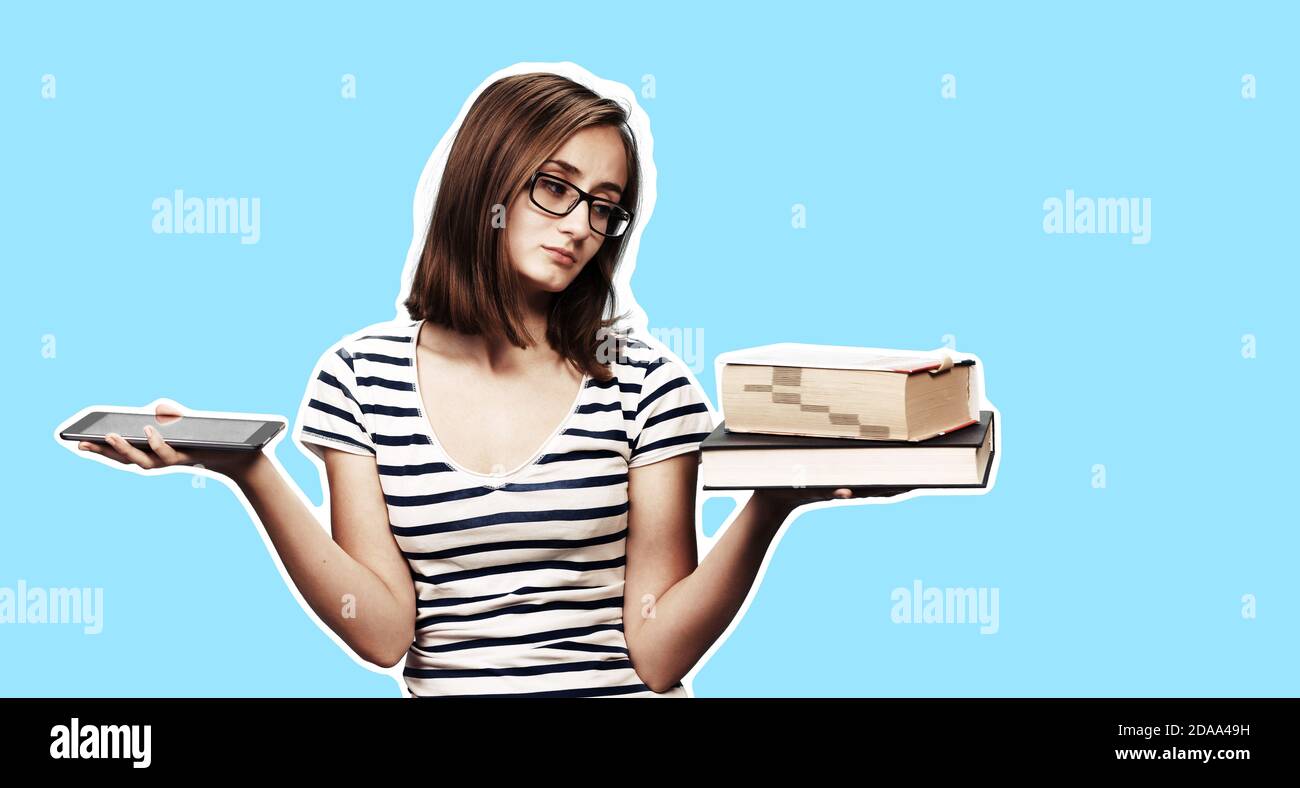 Contemporary education concept. Book vs e-book. Girl student holding ...