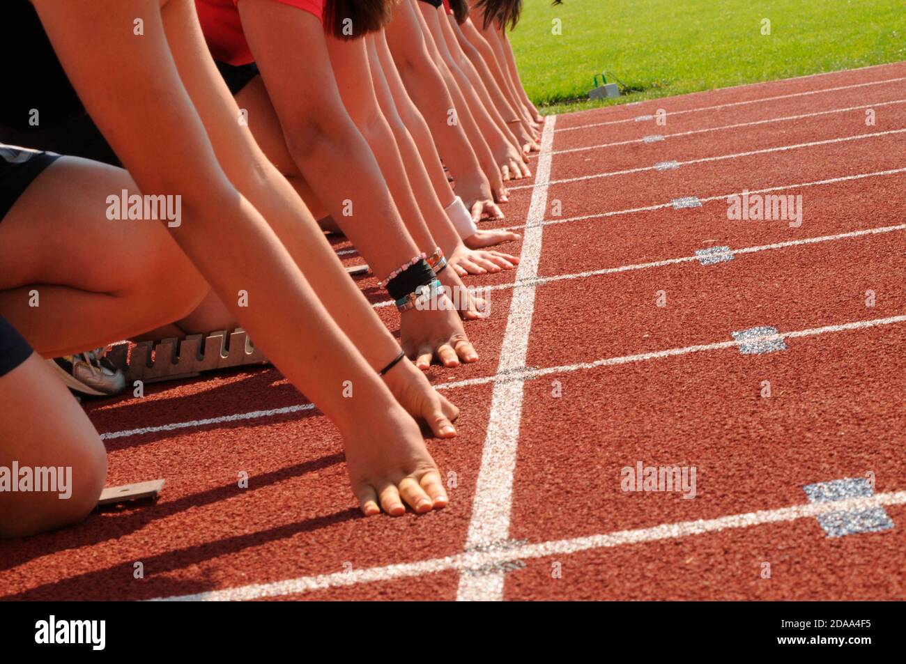 children in start position on the running track, running sport in the ...