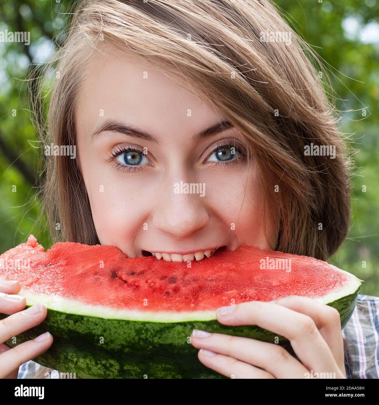 Young woman with watermelon outdoors Stock Photo - Alamy