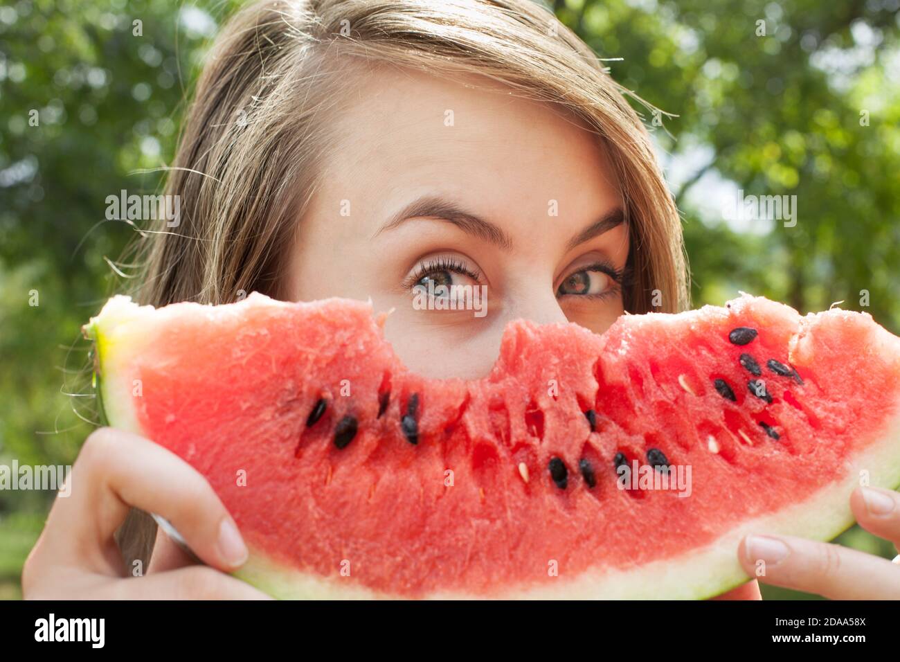 Young woman with watermelon outdoors Stock Photo - Alamy