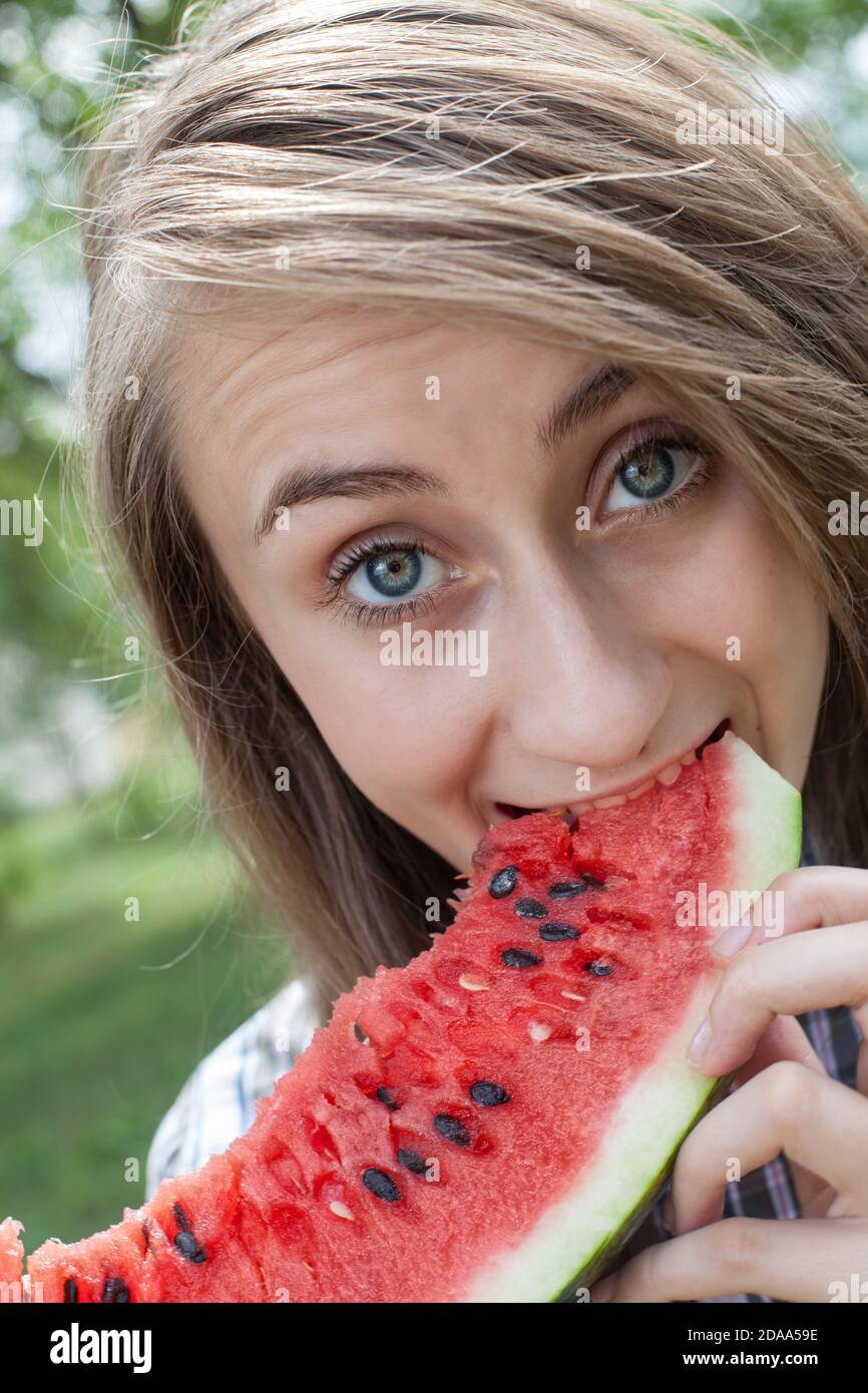 Young woman with watermelon outdoors Stock Photo - Alamy