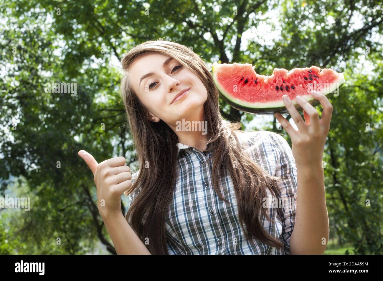 Young woman with watermelon outdoors Stock Photo - Alamy