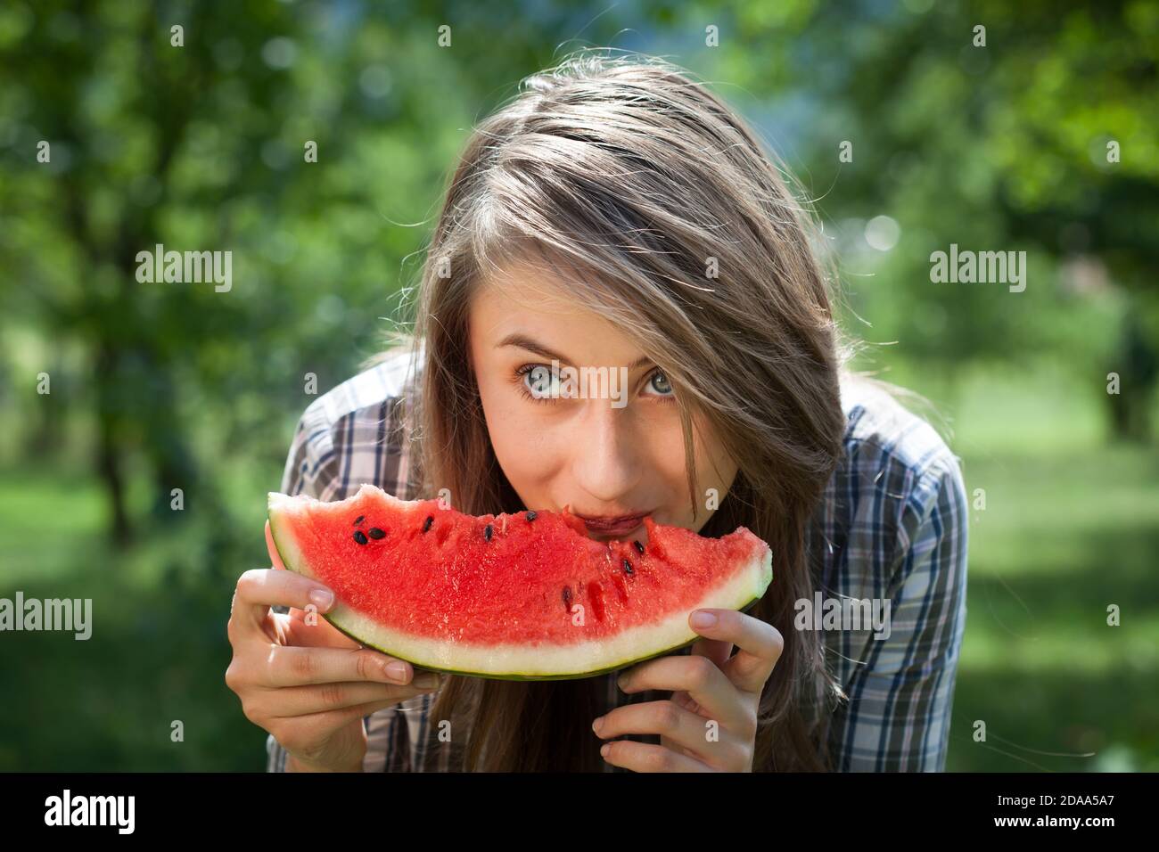 Young woman with watermelon outdoors Stock Photo - Alamy