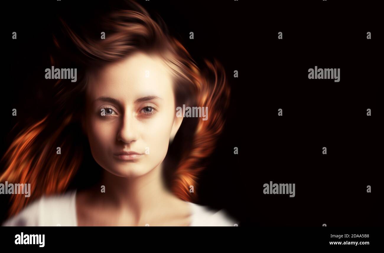 Portrait of a beautiful young woman with blurred hair on a dark ...