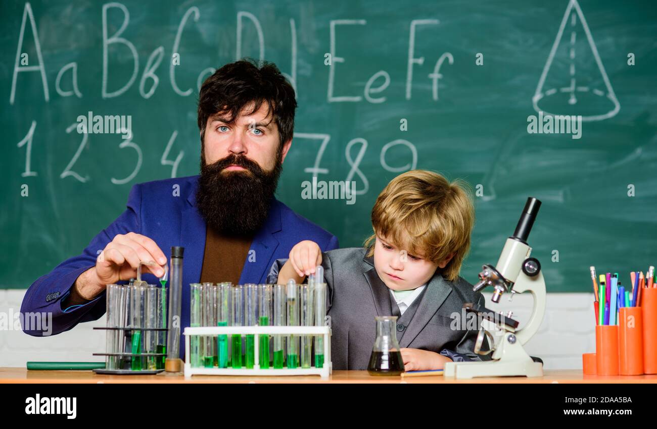 Little kid learning chemistry in school laboratory. father and son at ...