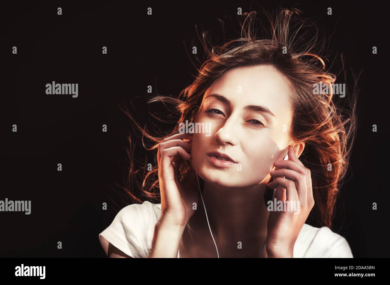 Beautiful Woman Listening Music on a dark background with copy-space ...