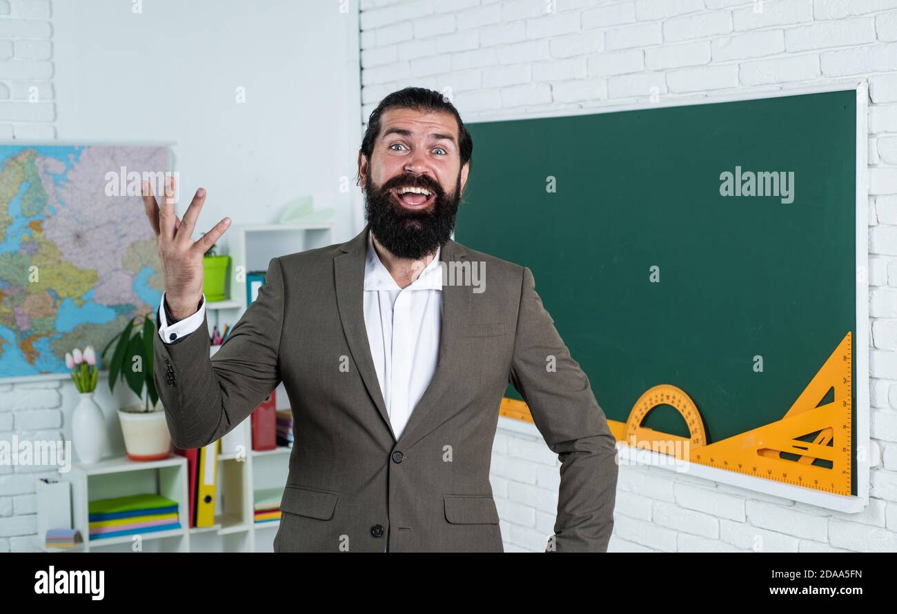 he is speaking. informal education. male student in school classroom ...