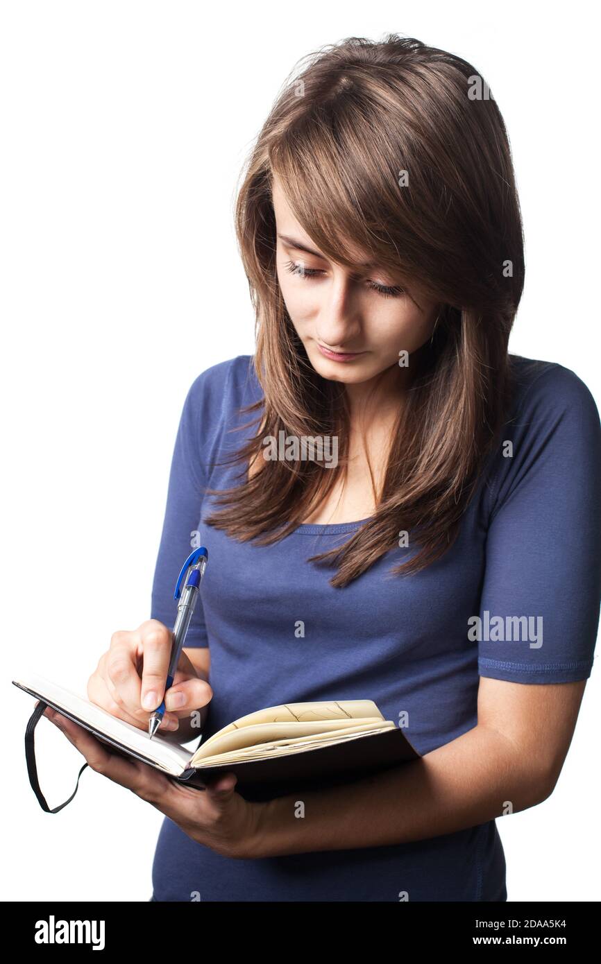 student with a pen and a notebook on a white background Stock Photo - Alamy