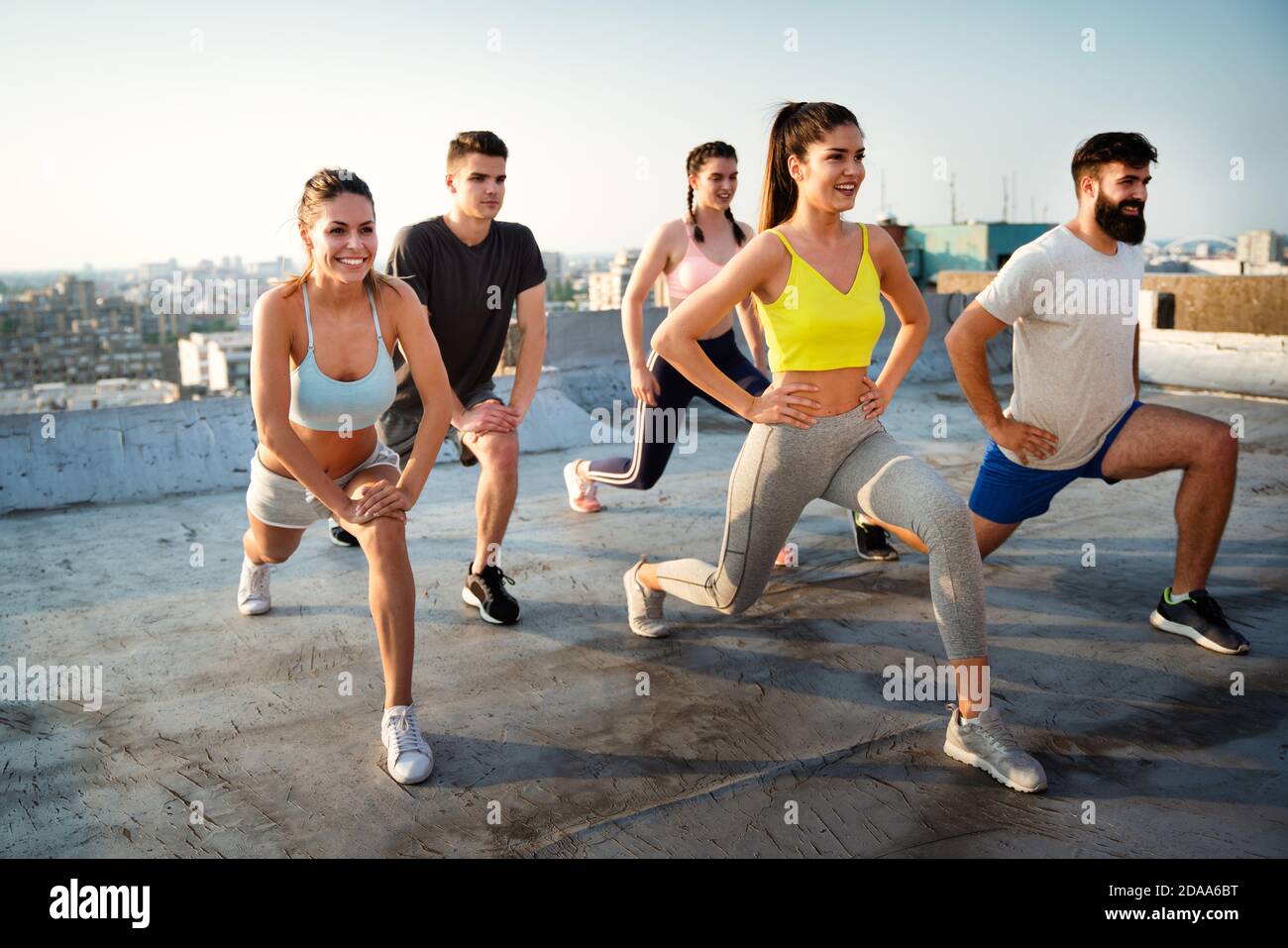 Group of fit healthy friends, people exercising together outdoor Stock ...
