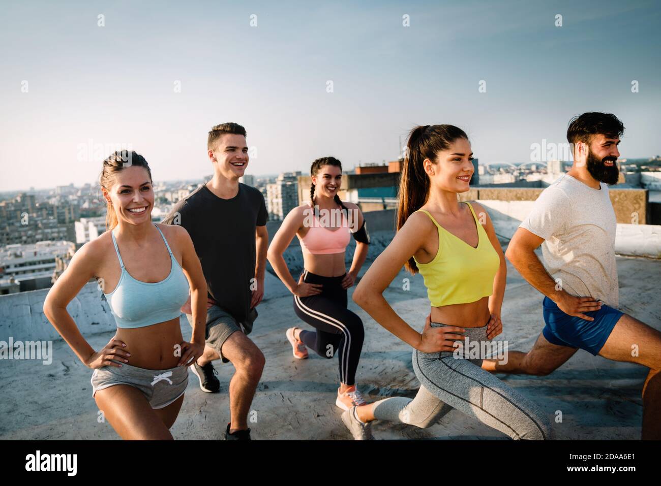 Group of fit healthy friends, people exercising together outdoor Stock ...