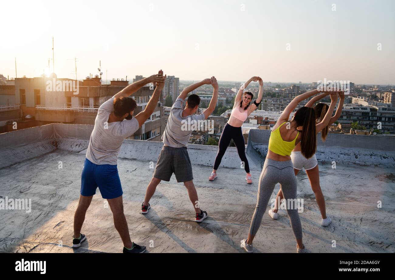 Portrait of smiling fit happy people doing power fitness exercise Stock ...