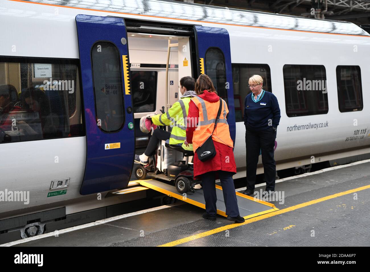 Train and station staff at Preston railway station help a disabled ...