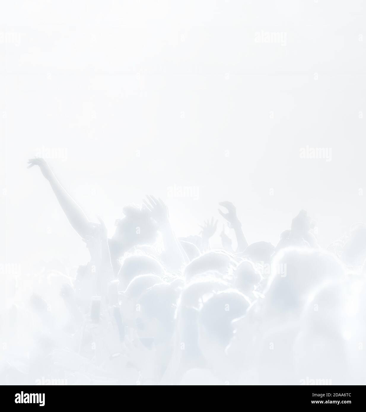 Crowd of spectators at a concert in light blue tonality. High key ...