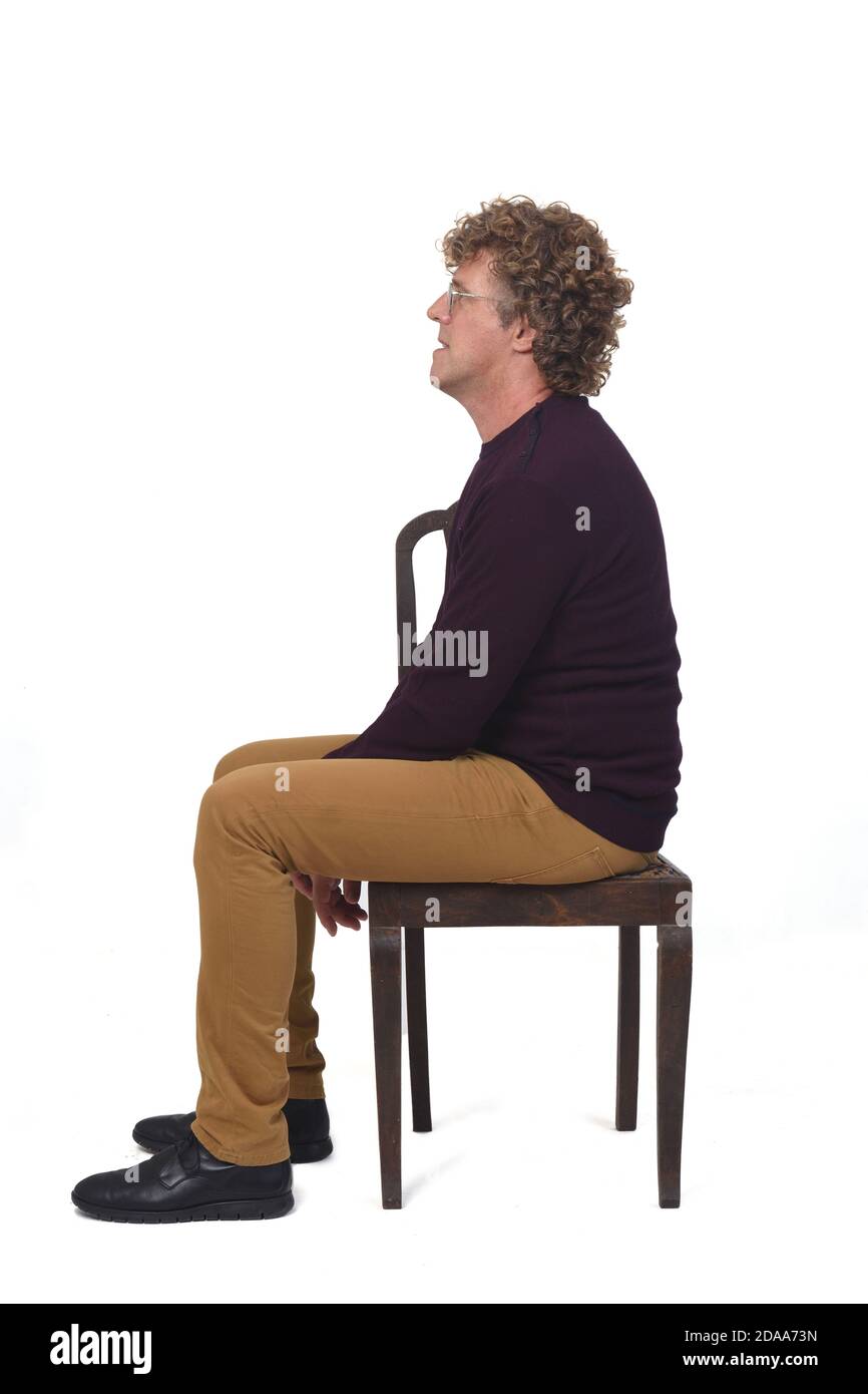 side view of a man sitting on white background Stock Photo - Alamy