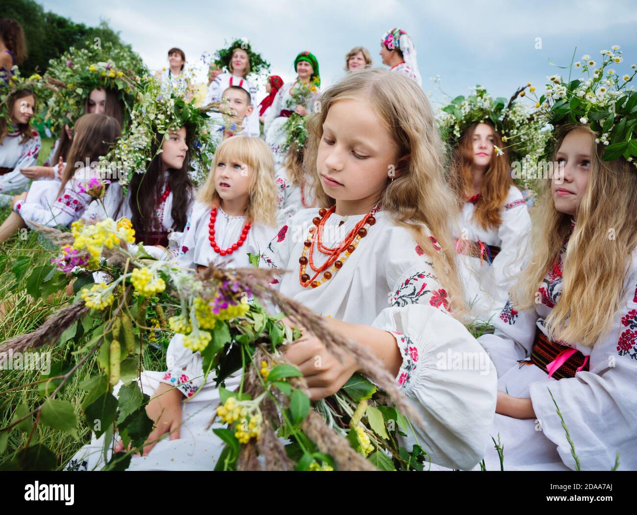 KIEV, UKRAINE - Jul 06: Young girls make wreaths of flowers celebrating ...