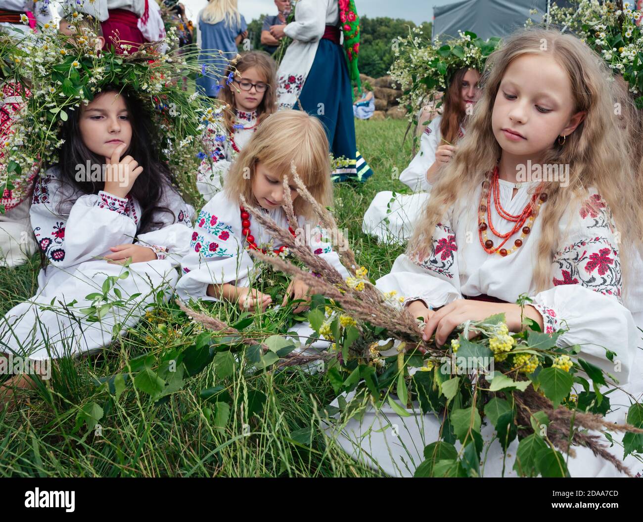 KIEV, UKRAINE - Jul 06: Young girls make wreaths of flowers celebrating ...