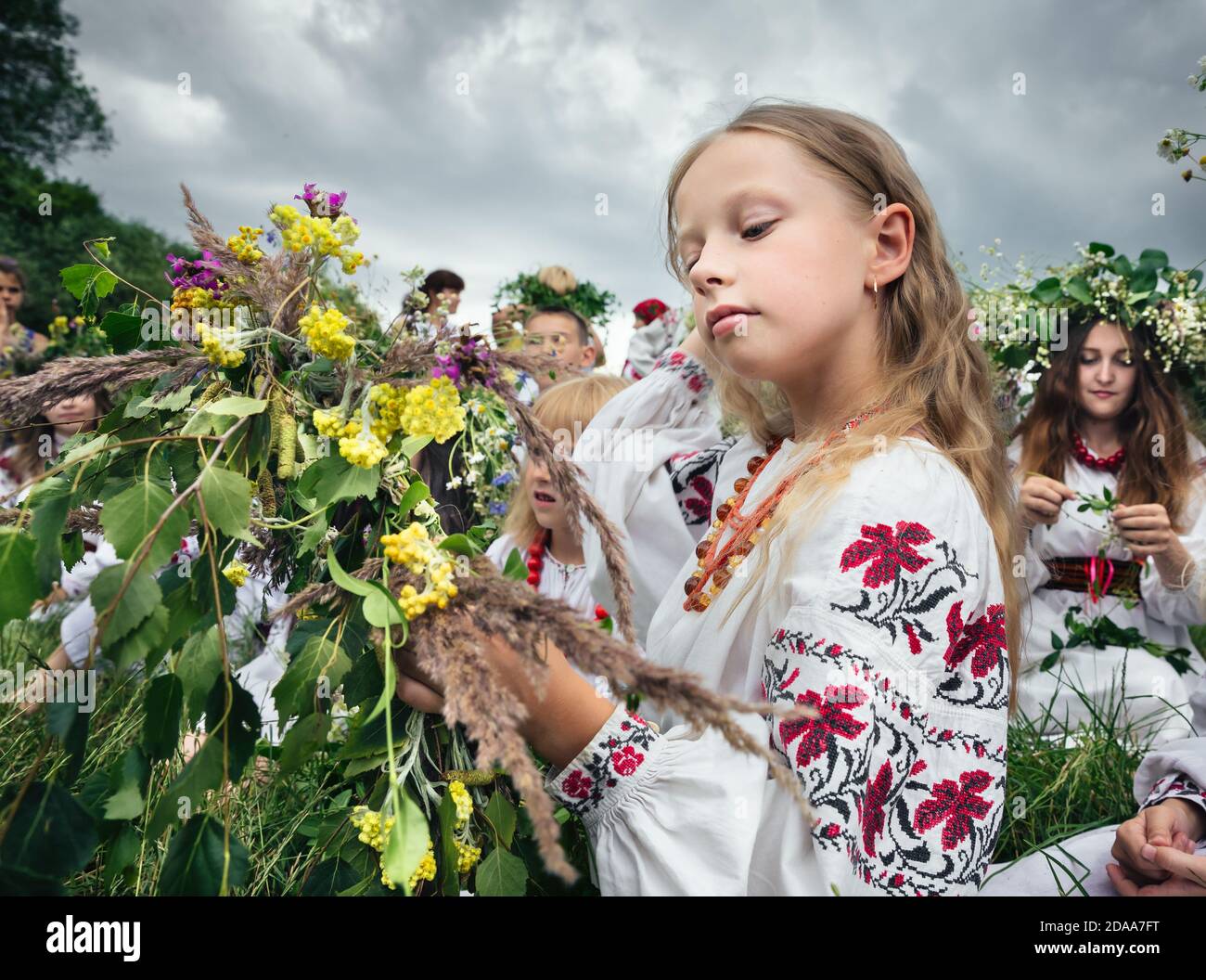 KIEV, UKRAINE - Jul 06: Young girls make wreaths of flowers celebrating ...