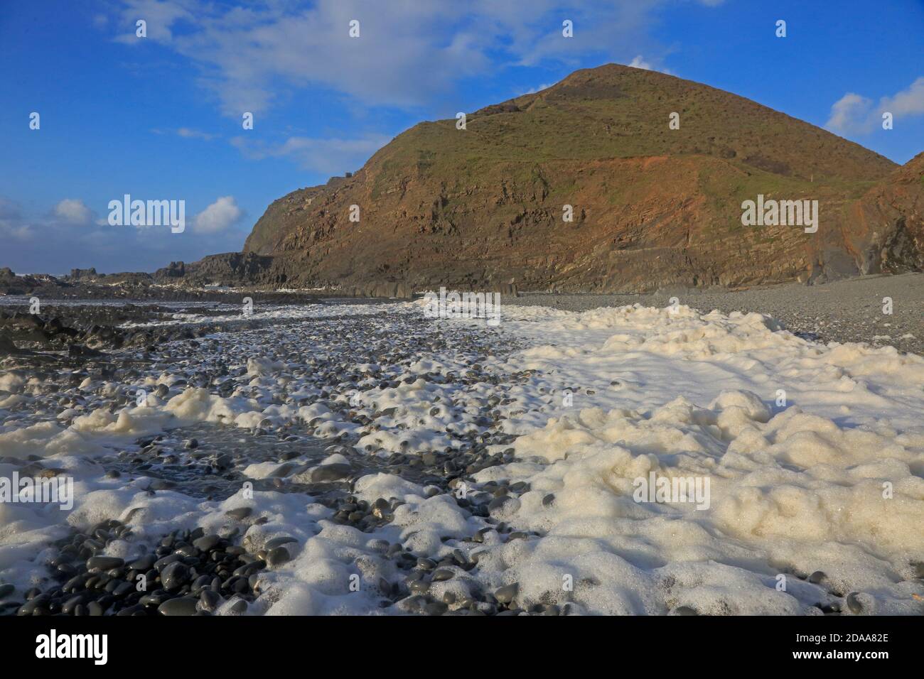 Sea Spume on the beach at Welcombe Mouth during a storm in Cornwall ...