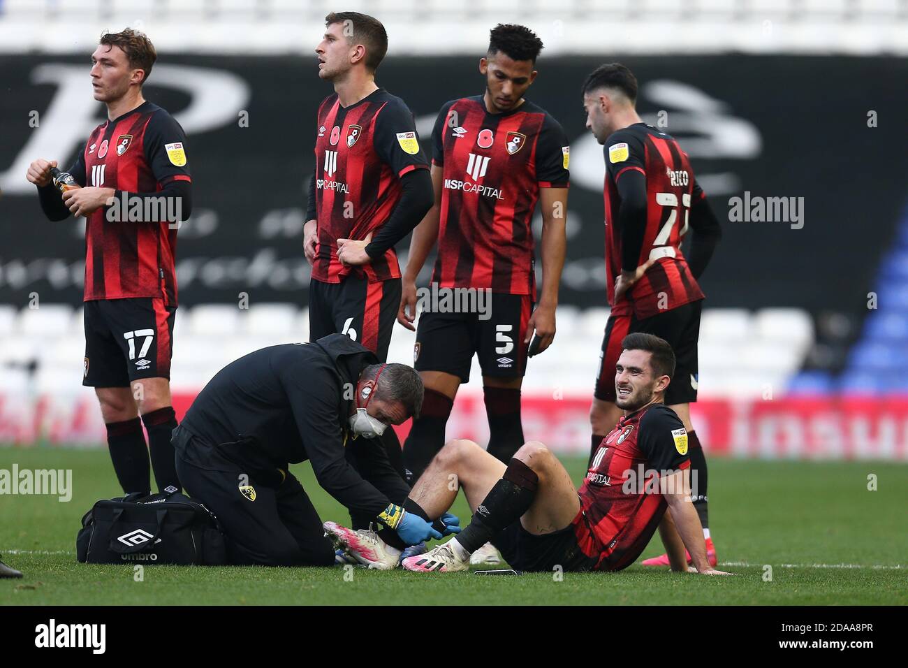 Lewis Cook #16 of Bournemouth receives treatment from the physio Stock ...