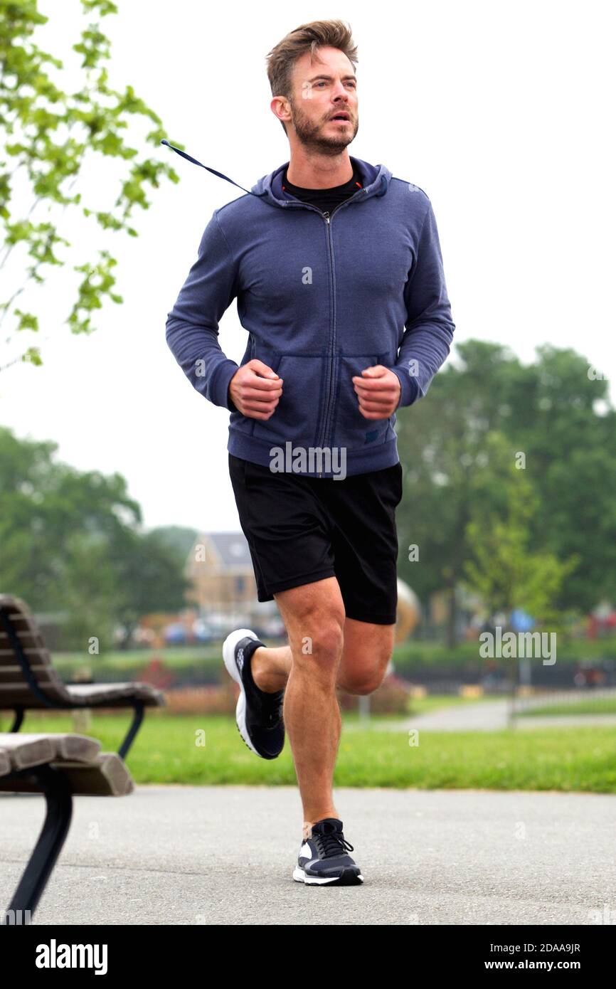 Full length portrait of Attractive middle age runner in park Stock ...