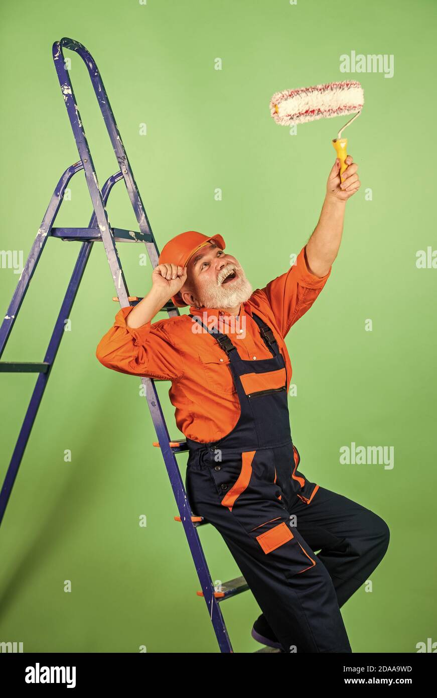 Painter man staircase. To make repairs. man in working clothes painting ...