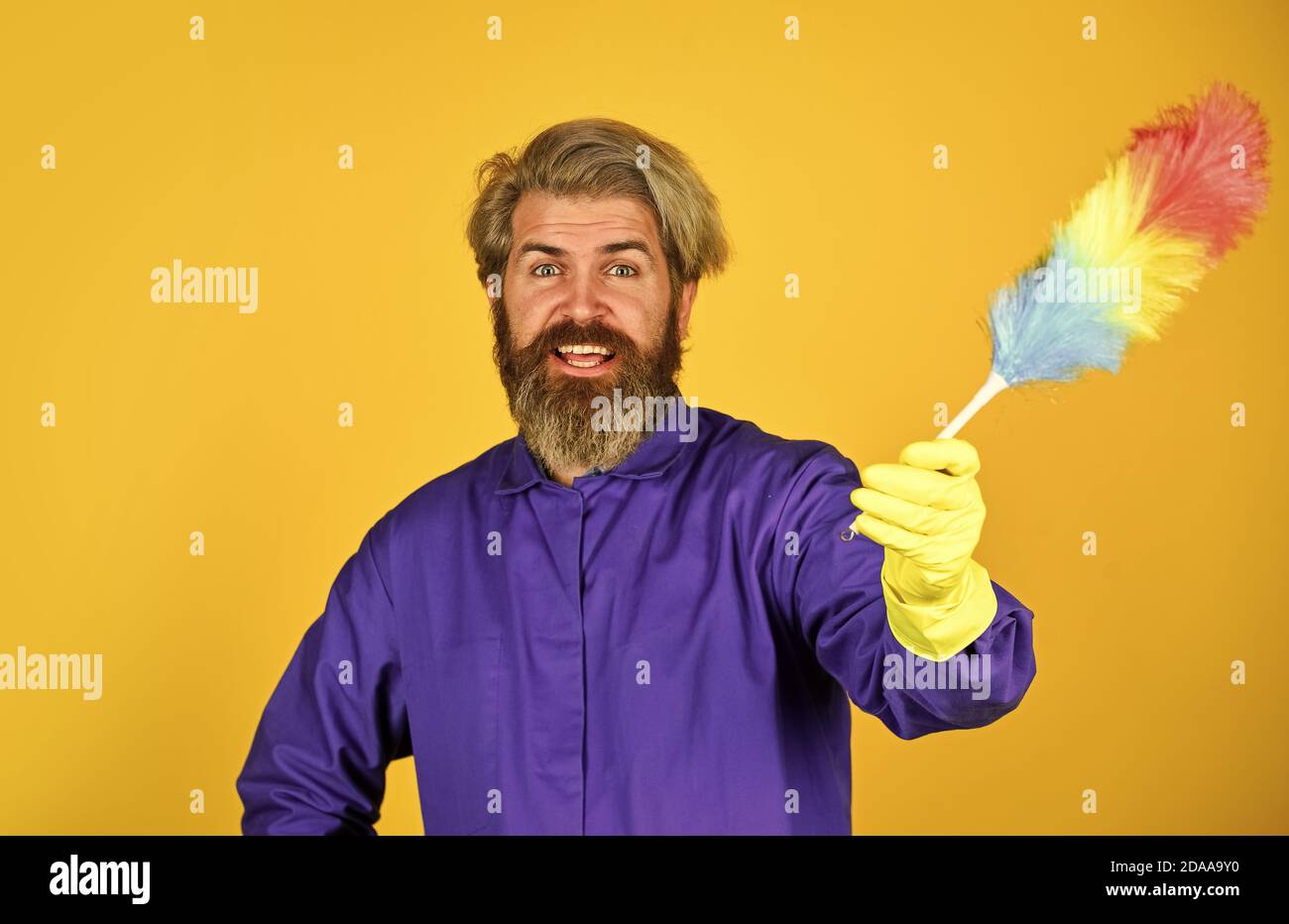 Husband cleaning home. Polypropylene duster. Hipster hold cleaning tool ...