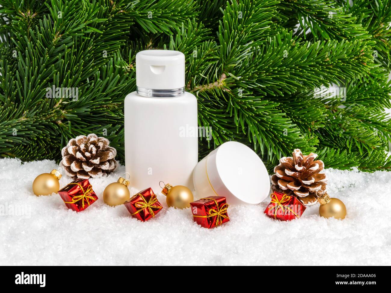 Set of winter skin care cosmetic products in snow under Christmas tree ...