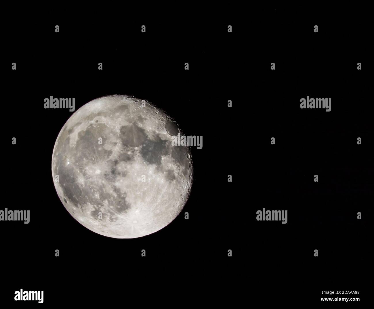 Nearly full autumnal moon, with seas and craters, over north London, UK ...