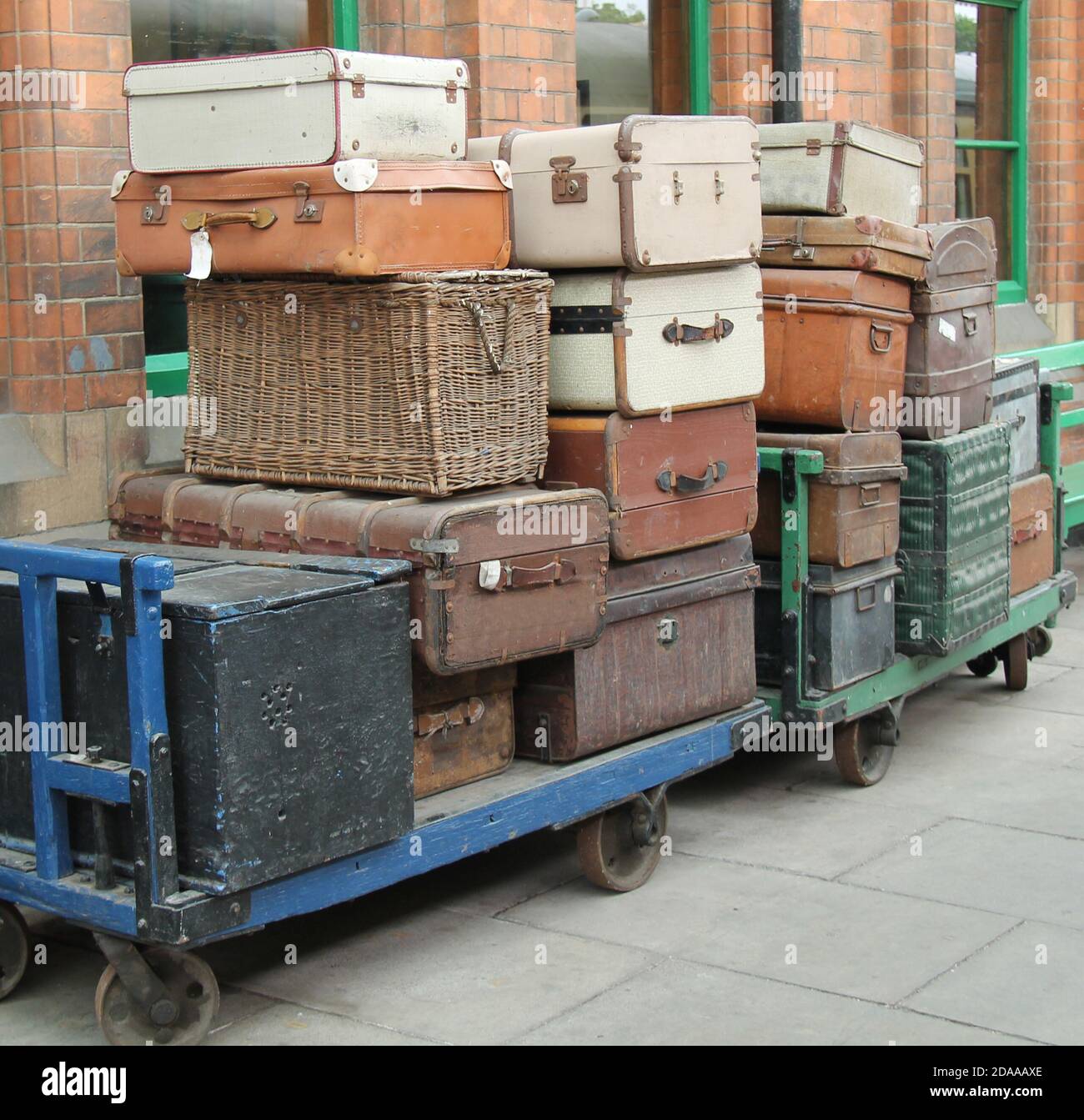 Two Vintage Luggage Trollies on a Railway Platform Stock Photo - Alamy