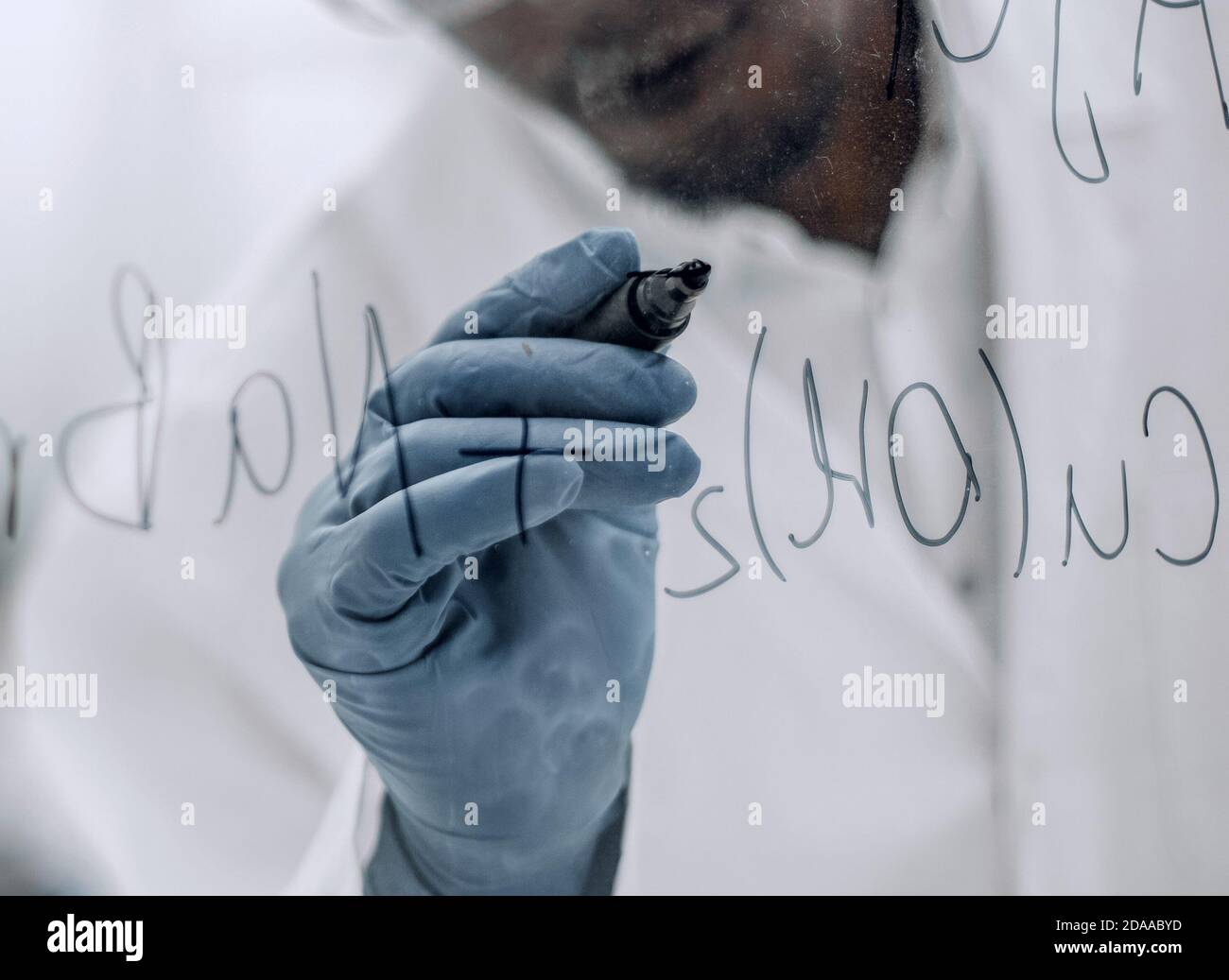 scientist writing chemical formula on a glass Board Stock Photo - Alamy