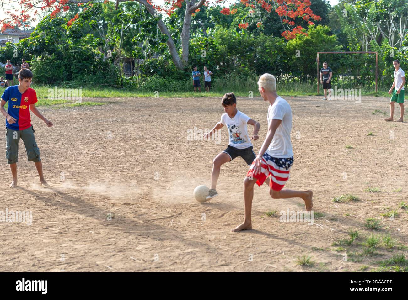 Cuban young people playing soccer or football in an abandoned field ...