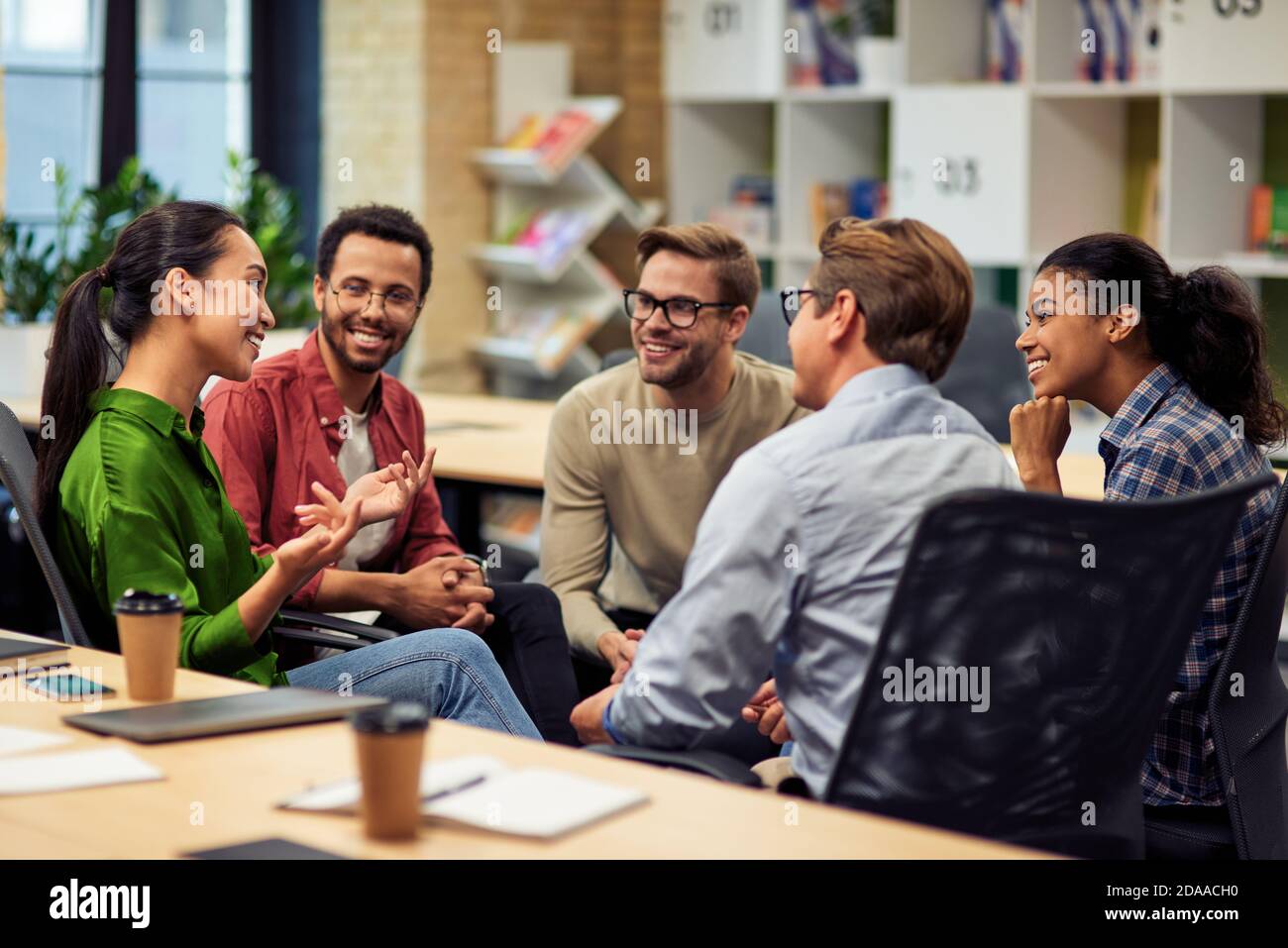 Creating success. Group of young happy multi racial business people ...