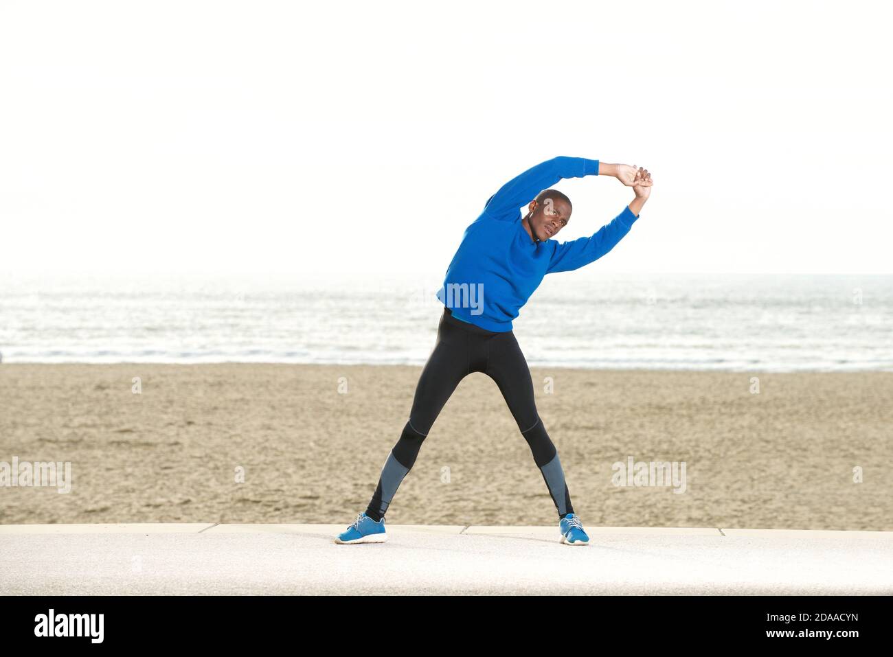 Full body portrait of african american man stretching muscles at the ...