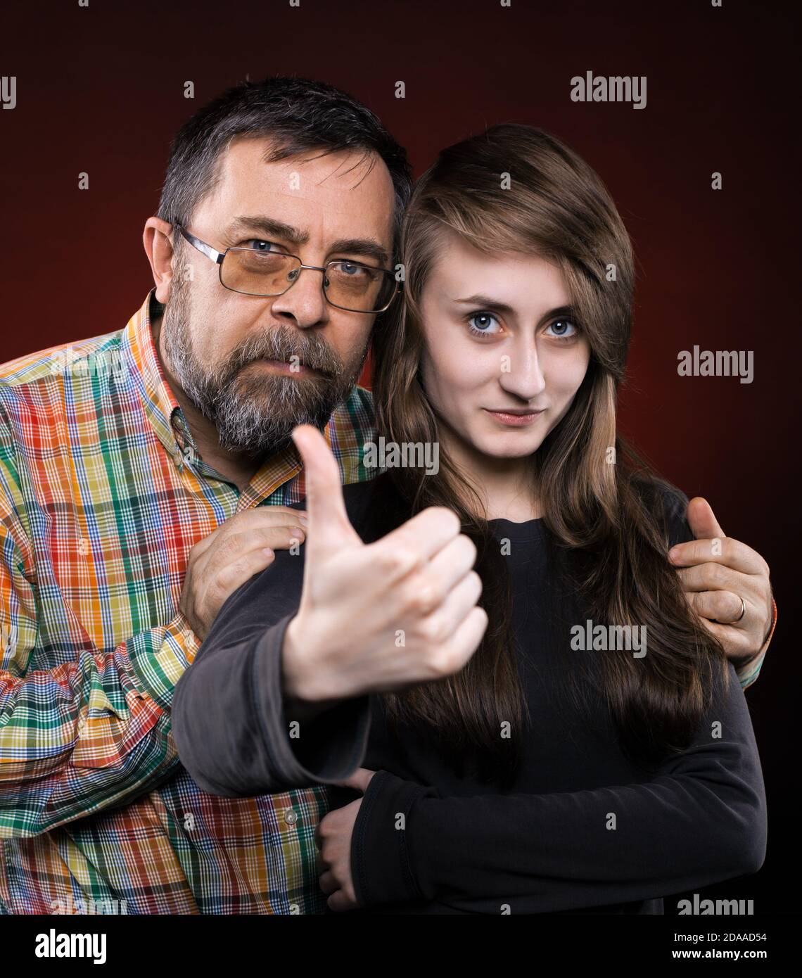 Studio portrait of a father and daughter. Show OK symbol Stock Photo ...