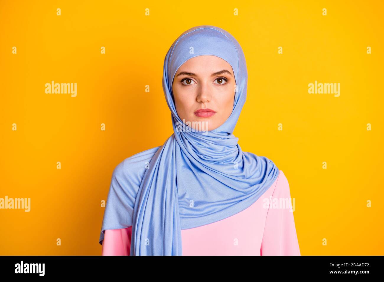 Close-up portrait of attractive serious content muslimah wearing blue ...