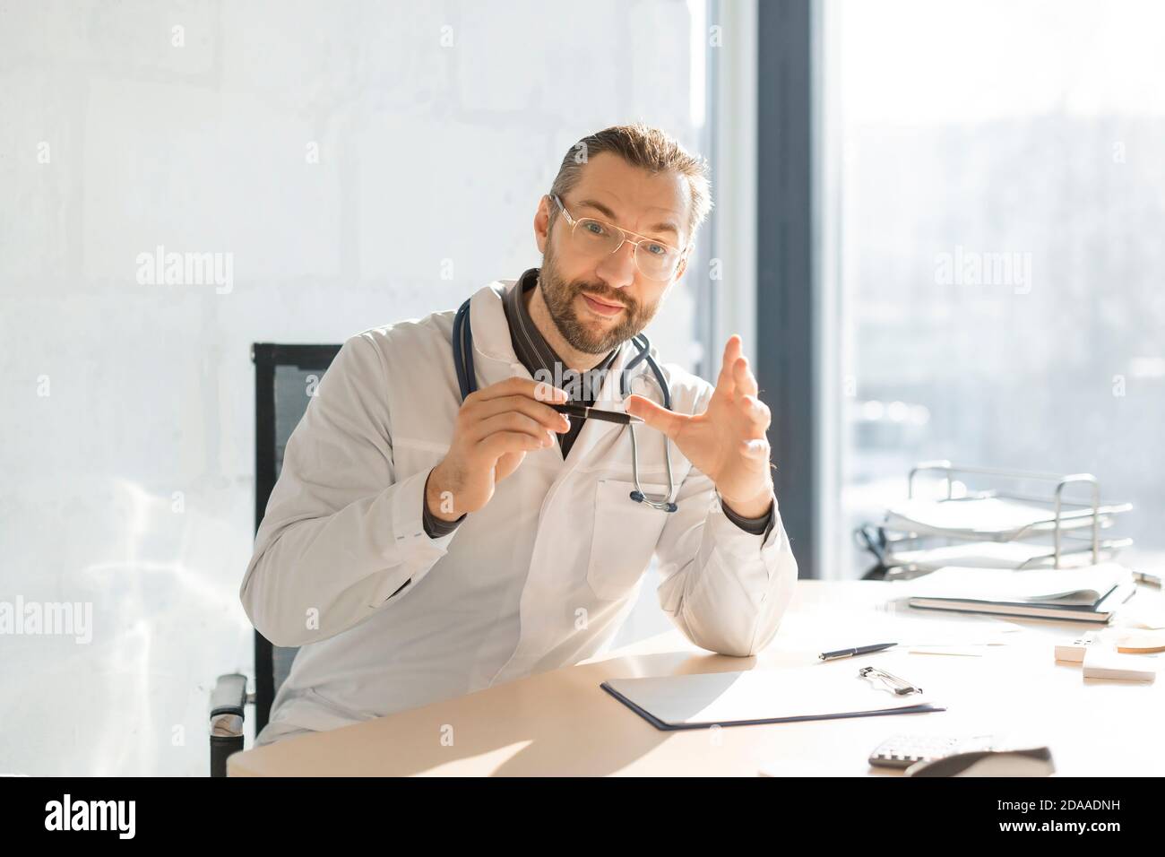 Medical doctor during online consultation. He explains to the patient ...