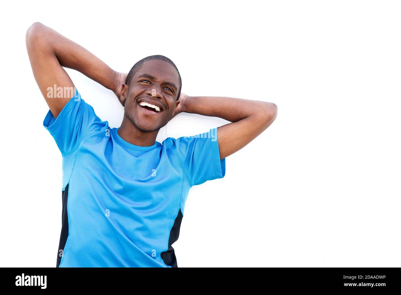 Portrait of cheerful young man laughing with hands behind head Stock ...