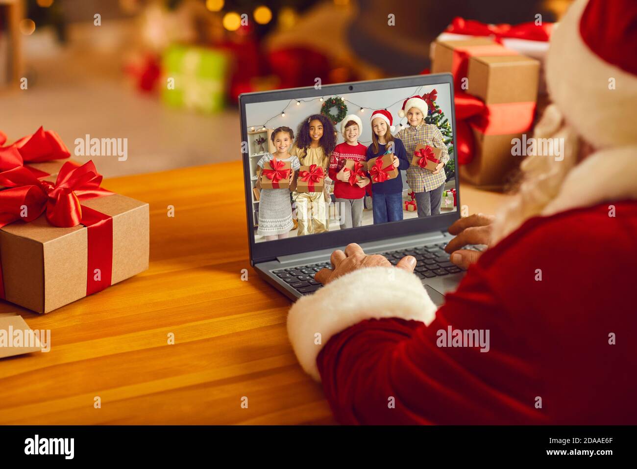 Santa Claus having video call with group of diverse kids using laptop ...