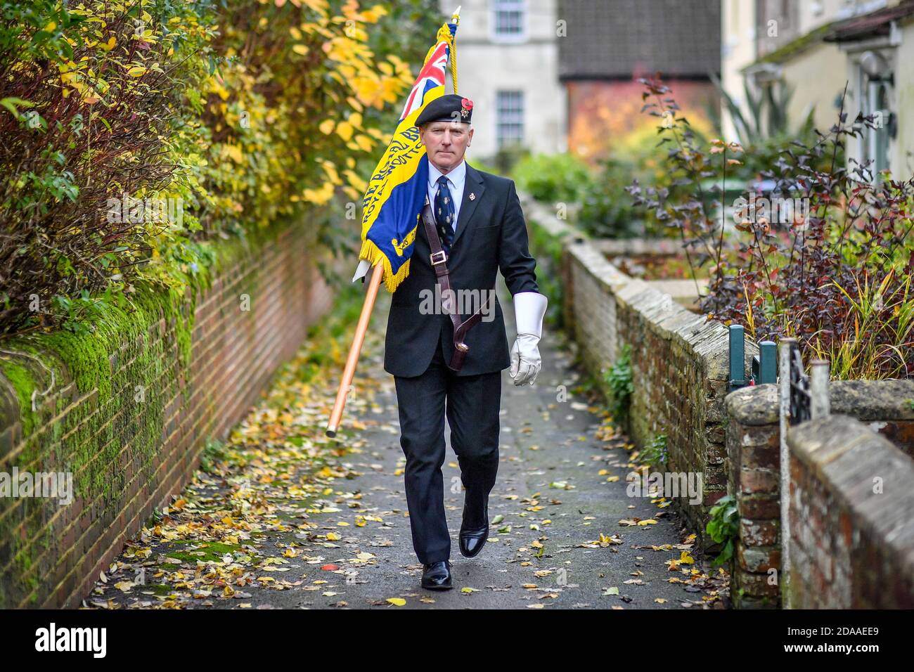 Royal British Legion standard bearer Richard Hignett makes his way to ...