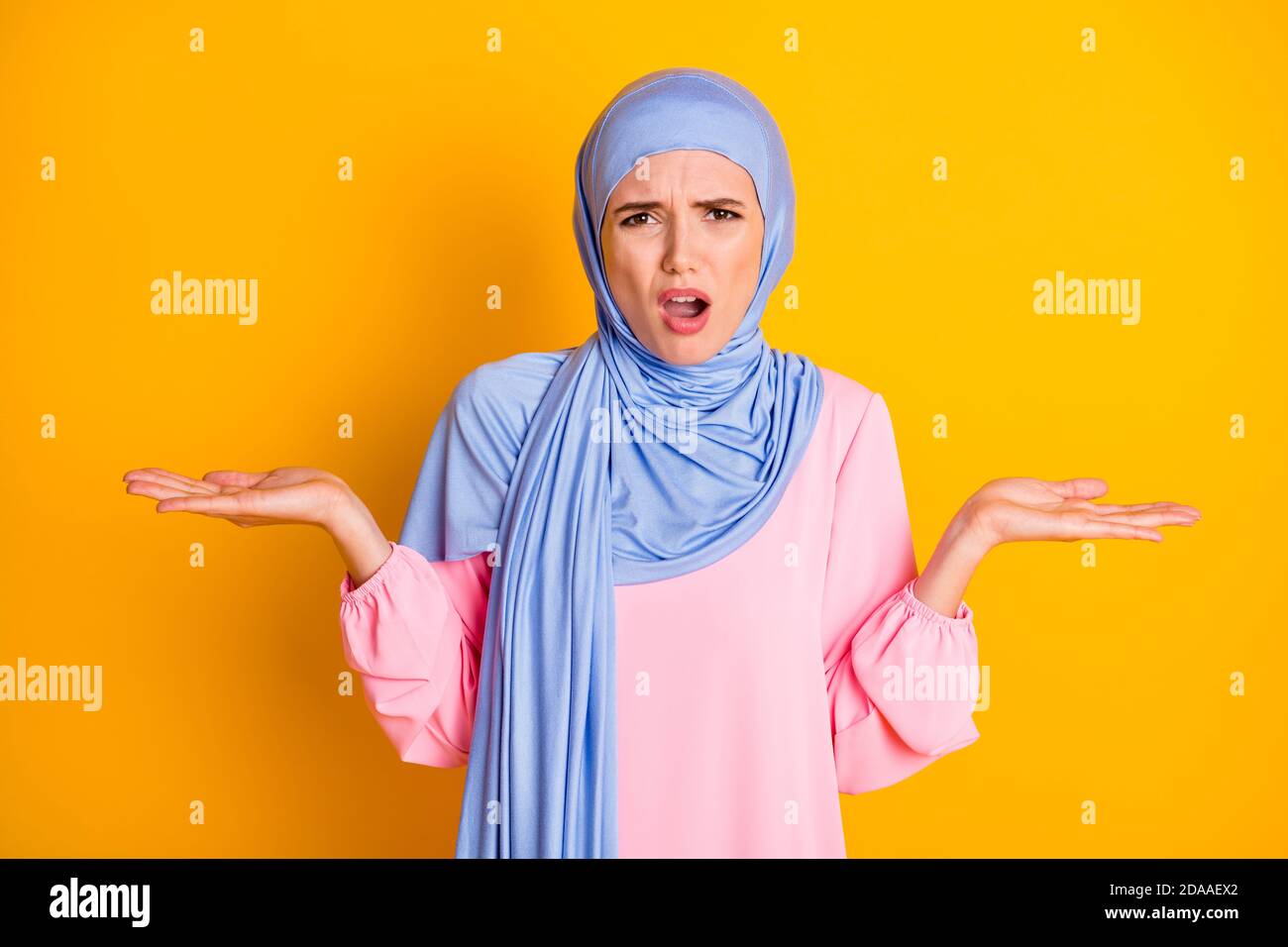 Portrait of pretty desperate muslimah wearing hijab indifferent ...