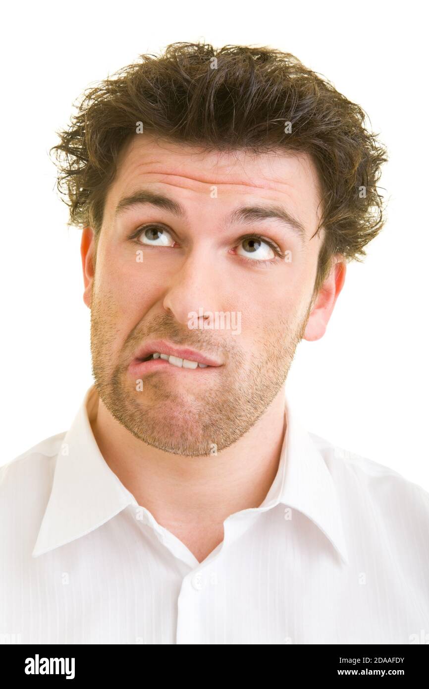 Young man bites his lip uncertainly Stock Photo - Alamy