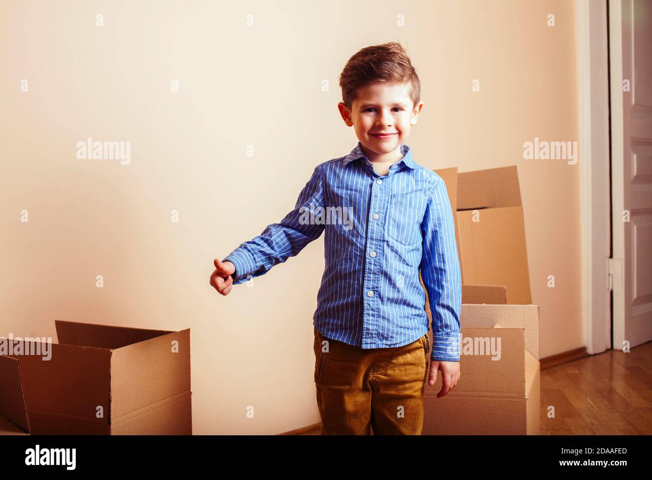 little cute boy in empty room, move to new house. home alone among ...